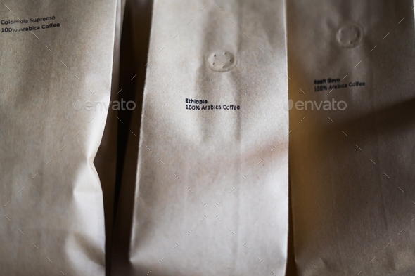 fresh grounded coffee in a brown paper bags. Stock Photo by ellinnur