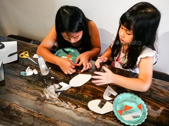 Children busy doing creative arts and craft. young girls siblings ...