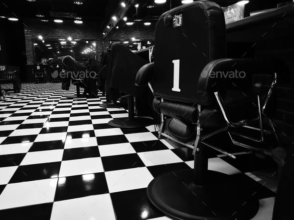 number 1 on chair at the barber shop with checkered floor in black and ...