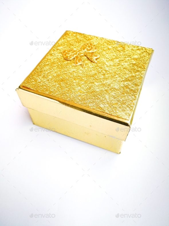 Gold metallic box isolated on white background. Stock Photo by ellinnur