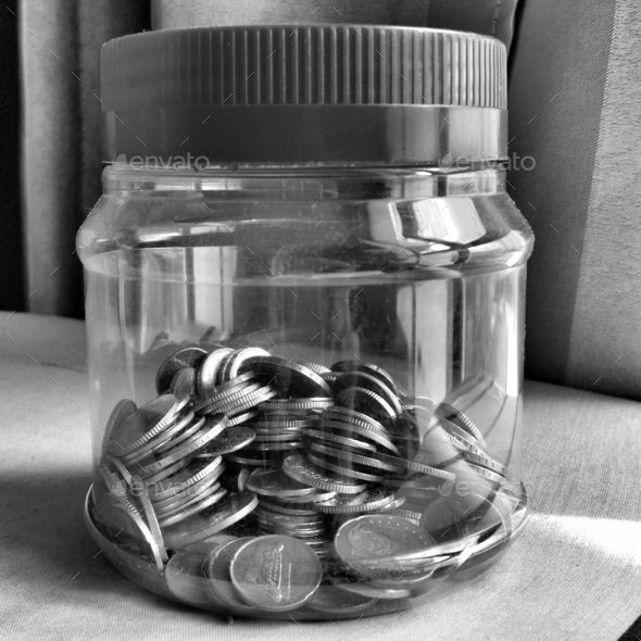 coins in a plastic container. black and white monochrome. Stock Photo ...