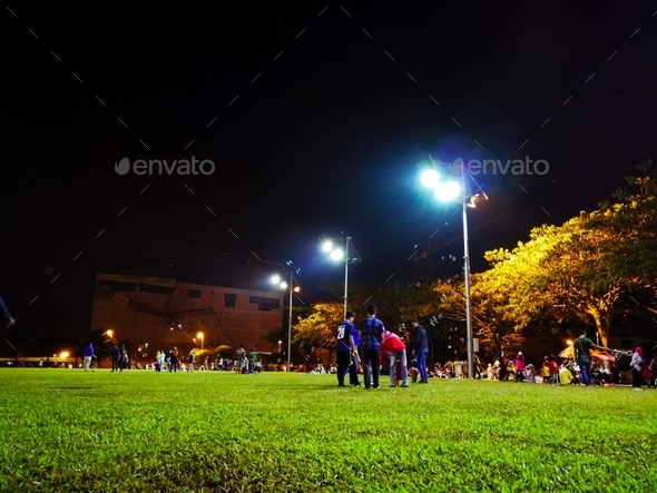 people recreational at the park in night time Stock Photo by ellinnur