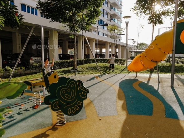 playground with lights and shadows during sunrise Stock Photo by ellinnur