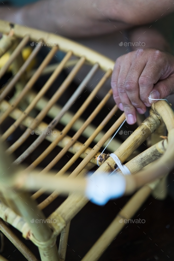 Close up hand tying white thread to the rattan chair. Stock Photo by ...