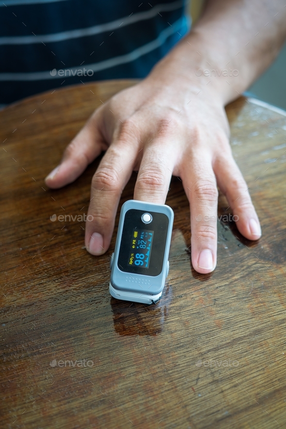 Pulse oximeter used to measure pulse rate and oxygen levels Stock Photo ...