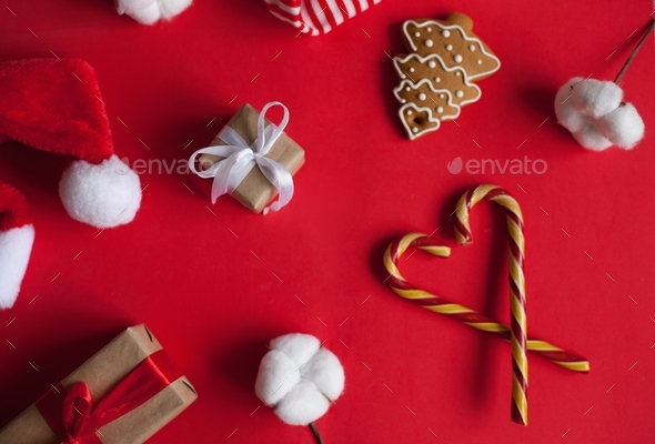 Candy canes shaped as heart, a gift box, christmas decor flat lay on ...