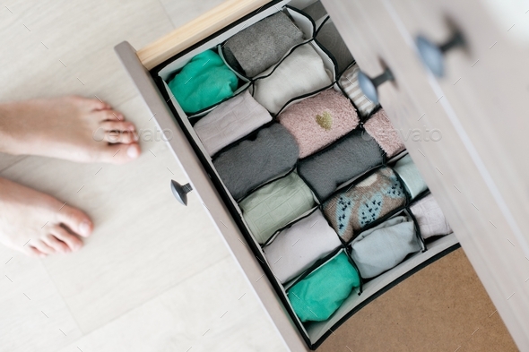 Organized socks drawer and feet shot from above, house chores, folding ...