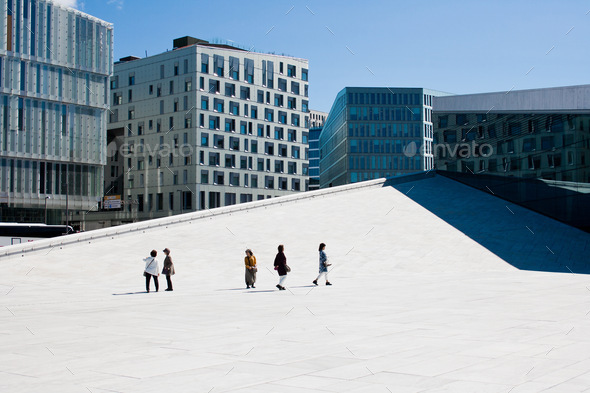 Five tourists walking on the roof of Opera House in Oslo, modern ...