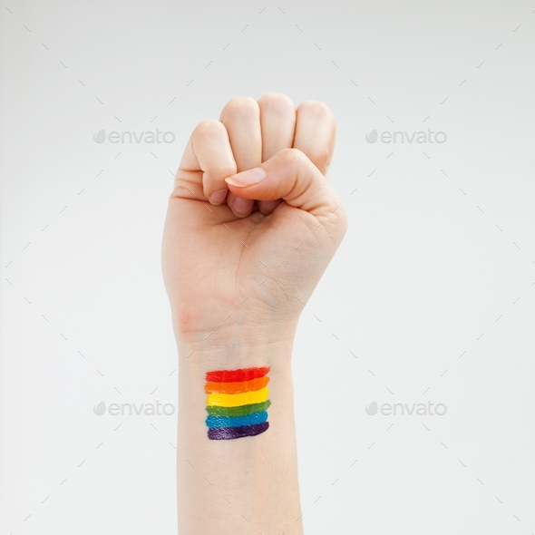A hand raised with painted rainbow, activism, lgbt, lgbtq+, equal ...