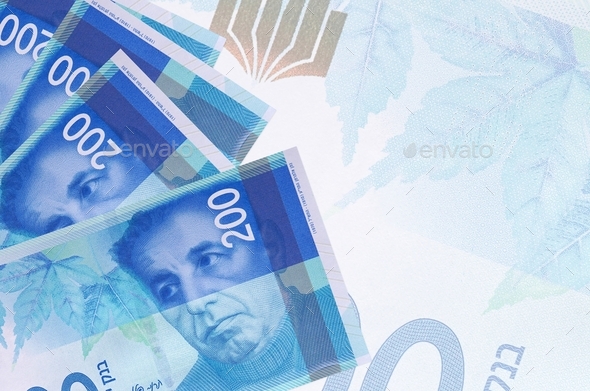 200 Israeli new shekels bills lies in stack on background of big semi ...