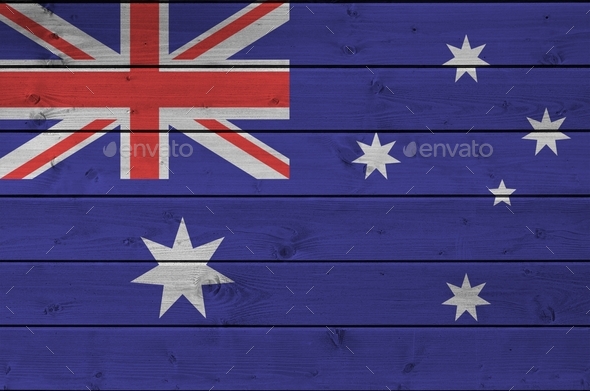 Australia flag depicted in bright paint colors on old wooden wall close ...