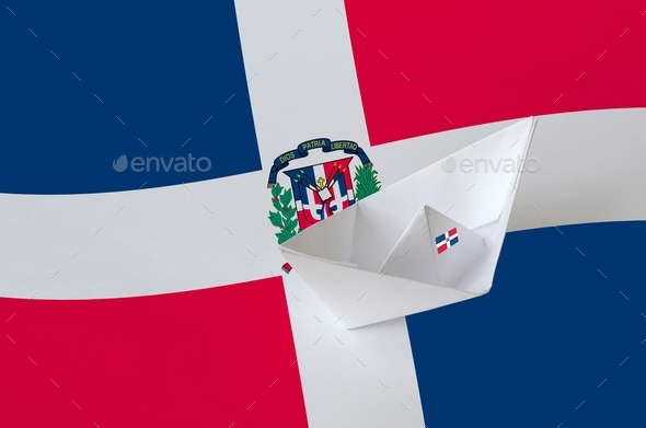 Dominican Republic flag depicted on paper origami ship closeup ...
