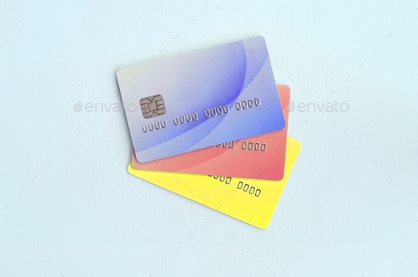 Three colored credit cards lay on a pastel blue background Stock Photo ...