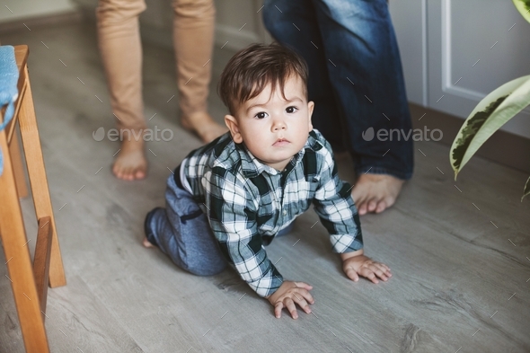 baby boy crawling on the floor learning to walk, happy kid with his ...