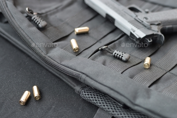 9mm bullets and pistol lie on a black tactical backpack Stock Photo by ...