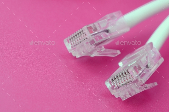White cord with connector rj45 on a bright pink background. network ...