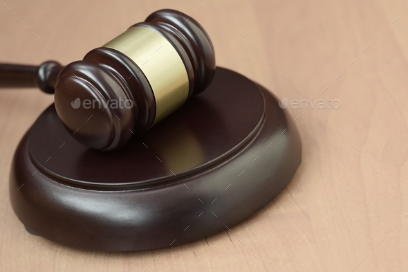 Justice mallet on wooden desk in a courtroom during a judicial trial ...