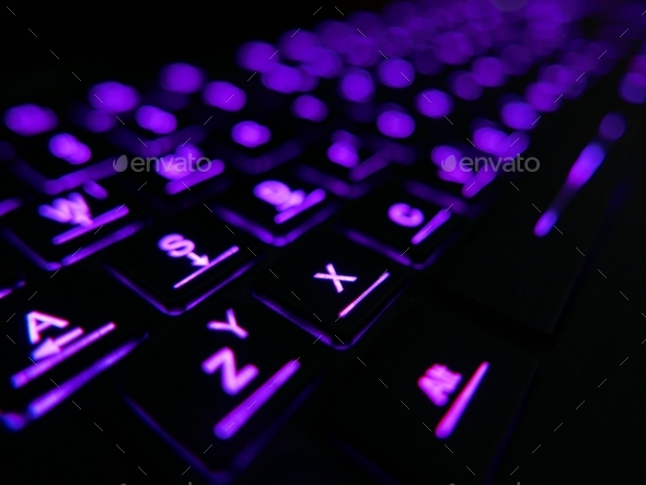 Close-up image of computer keyboard with purple illumination. Stock ...