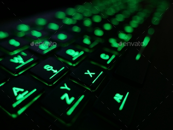Close-up image of computer keyboard with green illumination. Stock ...