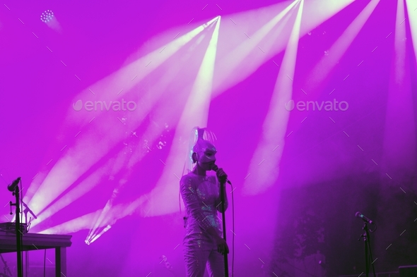 Singer on stage illuminated with purple spot lights. Stock Photo by 9 ...