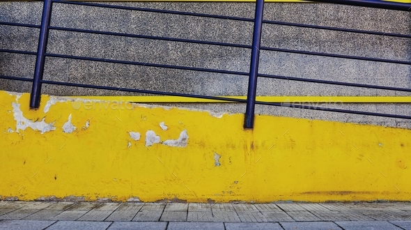 Side view of yellow wall and railing on building exterior. Stock Photo ...