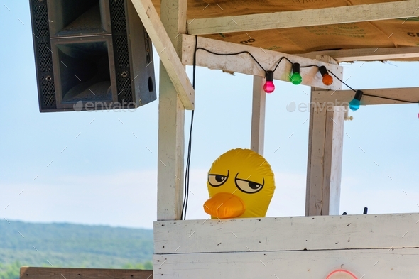 Funny photo of an inflatable duck behind a DJ counter in a beach bar ...
