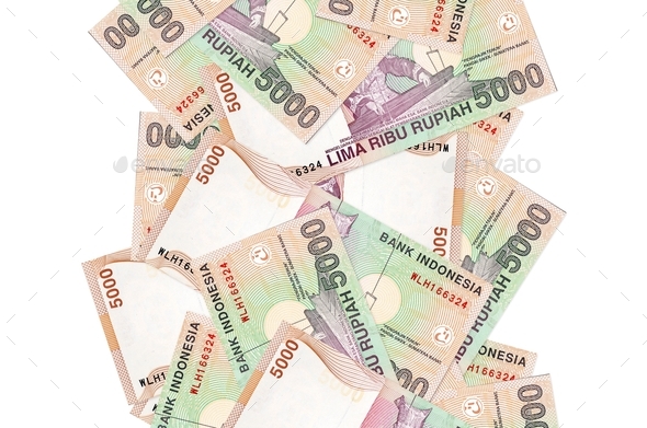 5000 Indonesian rupiah bills flying down isolated on white. Many ...