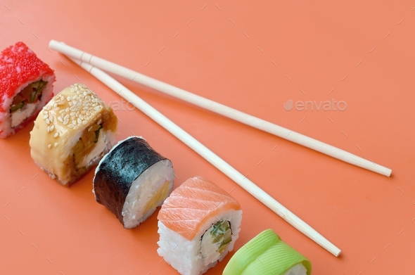 Different types of asian sushi rolls on orange background. Minim Stock ...