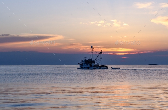 Fishing boat or ship sailing out to sea in sunset. Stock Photo by 9 ...