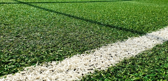 Close-up image of white line on artificial green football turf. Stock ...