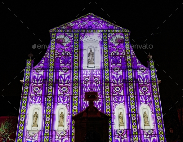 Light projection on building exterior. Colorful textures projected on a ...