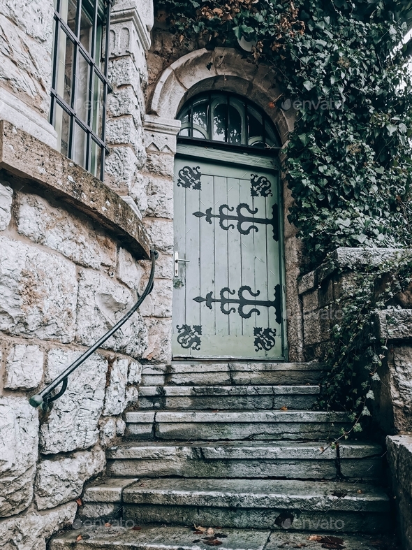 Old wooden door and entrance to old stone house. Stock Photo by 9_fingers_