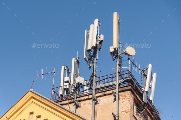Cluster of mobile network broadcast cell repeaters on roof of building ...