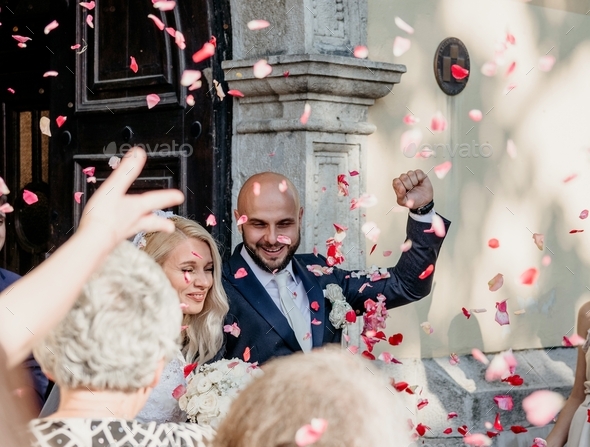 Rose petals thrown on bride and groom as they are walking out of church ...
