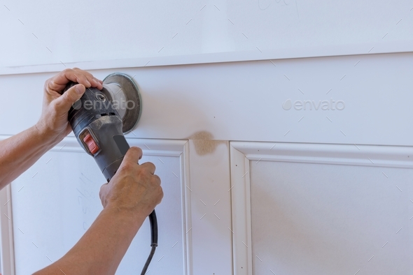 Professional worker polishing sanding the molding trim Stock Photo by ...