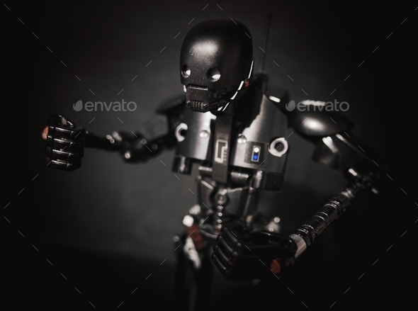 Black robot toy in front of a black background. K2SO character from ...