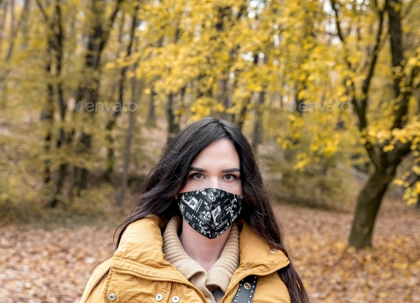 Portrait of attractive young woman wearing yellow jacket and black ...