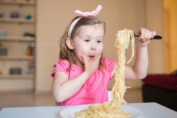 Funny face girl eating pasta Stock Photo by shapoval08 | PhotoDune