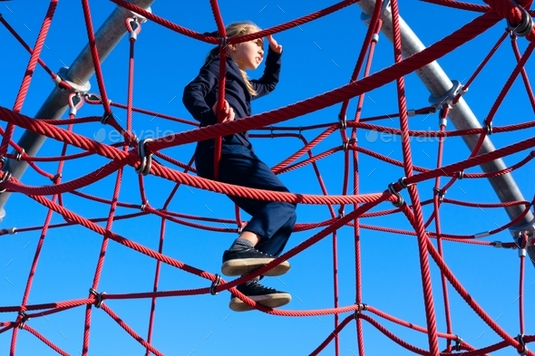 Child climbing rope ladders at outdoors playground Stock Photo by ...