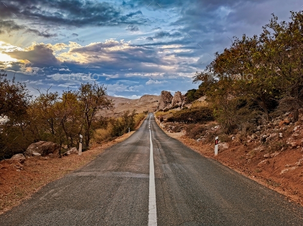 Empty open road with white dividing line through beautiful landscape ...
