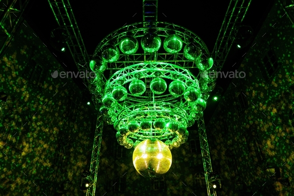 Green disco balls chandelier at a party venue. Stock Photo by anelehbakota