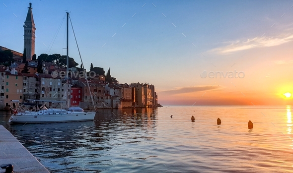 Sunset over ocean behind a picturesque seaside town in Rovinj, Croatia ...