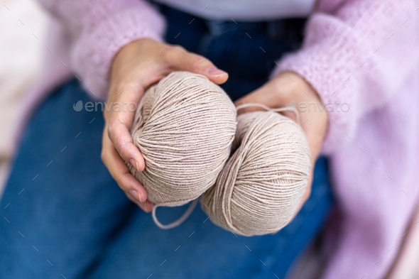 female hands holding balls of yarn Stock Photo by aliliya | PhotoDune