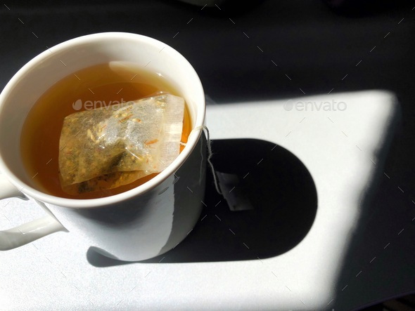 Teacup with the tea bag inside it and the shadow Stock Photo by ...
