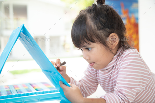 Little kids drawing with a colored pencil is a good activity for ...