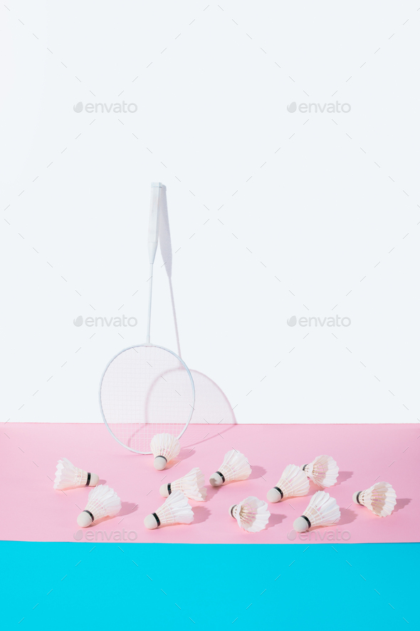 badminton racket and shuttlecocks on blue and pink papers at wall Stock ...