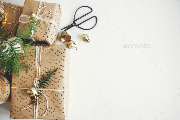 Stylish christmas gifts flat lay. Modern presents with fir branch ...