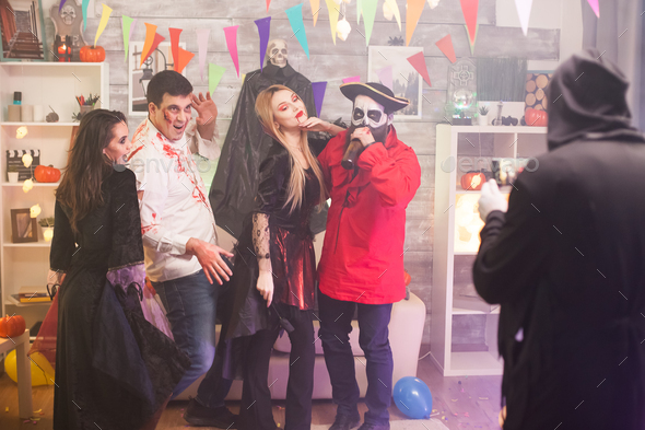 Back view of grim reaper taking a photo of monsters Stock Photo by DC ...