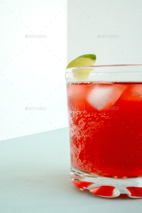 Red sparkling drink with lime slice Stock Photo by phoenixproduction