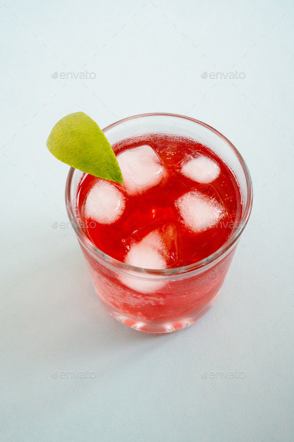 Red sparkling drink with lime slice Stock Photo by phoenixproduction